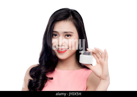 Young asian woman holding jar with savings angry and mad screaming ...