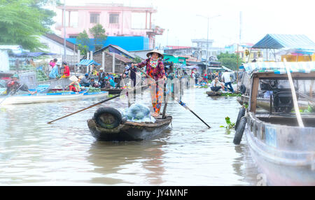 Ferryman rowing takes visitors across river to visit floating market ...