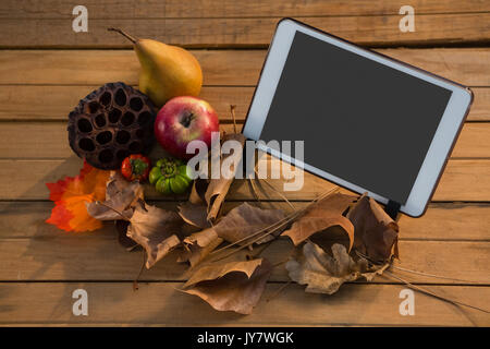 Fresh fruits and a Tablet PC on wooden table. Healthy eating concept ...