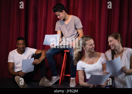 Actors reading their scripts on stage Stock Photo - Alamy