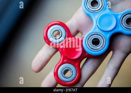 A person holding popular fidget spinner toy Stock Photo - Alamy