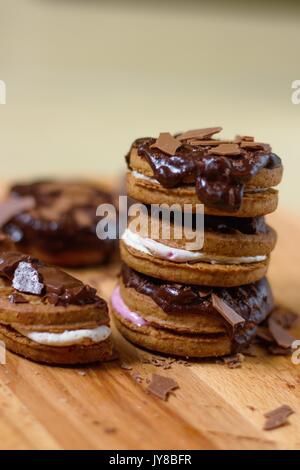 Stack rich dark chocolate cookies on light rustic wooden background ...