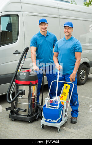 Two Happy Cleaners With Cleaning Equipments In Office Stock Photo - Alamy