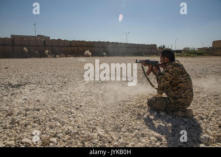 A Syrian Arab trainee fires his rifle at a marksmanship range in ...