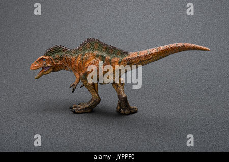 side view acrocanthosaurus toy with shadow on a white background Stock ...