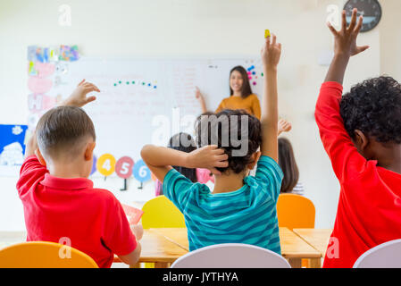 teacher asking question with children in classroom Stock Photo - Alamy