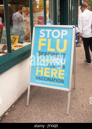 Sign outside pharmacy stop flu before it stops you Stock Photo - Alamy