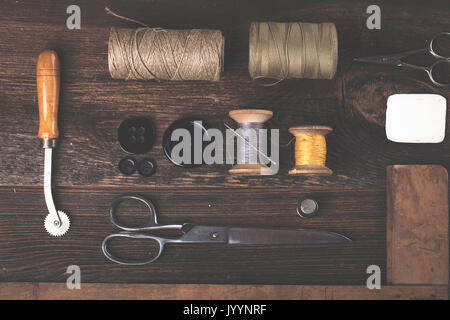 Closeup of materials, threads and needles in sewing workshop Stock ...