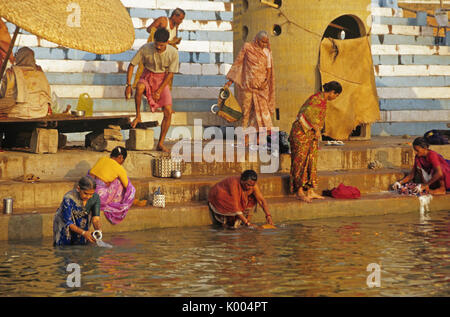 Men bathing in morning, at ghats of holy Ganges river, also Ganga river ...