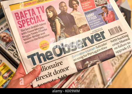 LONDON, ENGLAND - MAY 14, 2017 : A hand holding The Sunday people ...