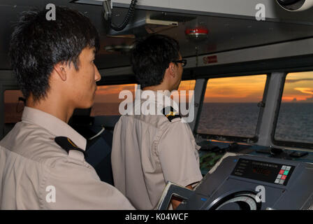 Navigational officer lookout on navigation watch looking through ...
