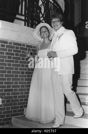 1970, historical, a couple walking on the grass in a park, the man ...