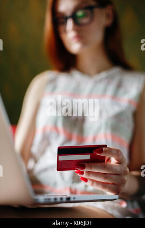 Close up of anonymous customer paying with gold credit card in small ...