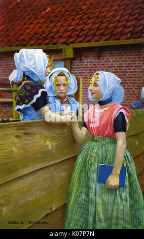 Dutch girl in traditional costume holding a huge bunch of red and ...