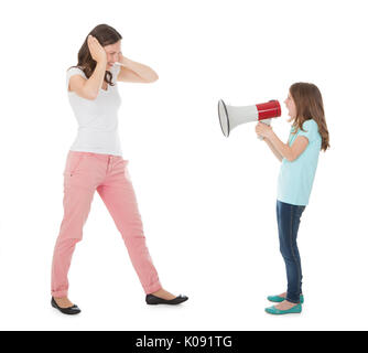 Angry mother shouting at her daughter isolated on white background ...