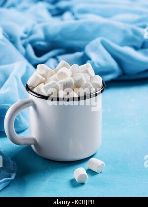 Marshmallows on blue background with copyspace Stock Photo - Alamy