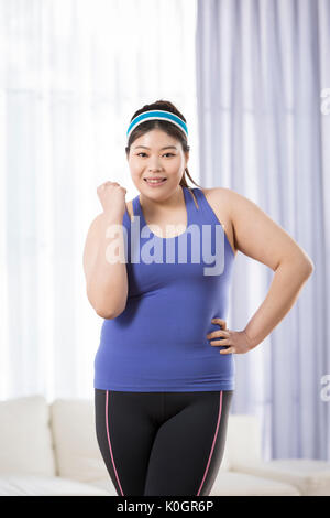Young smiling confident fat woman cheering Stock Photo - Alamy