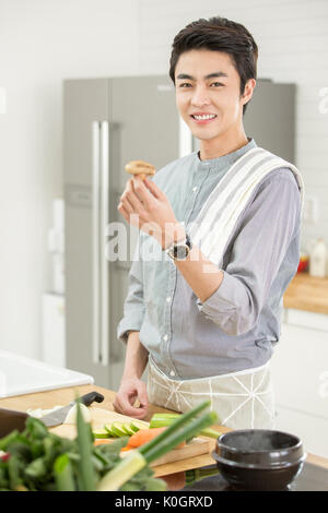 Smiling single man cooking Stock Photo - Alamy