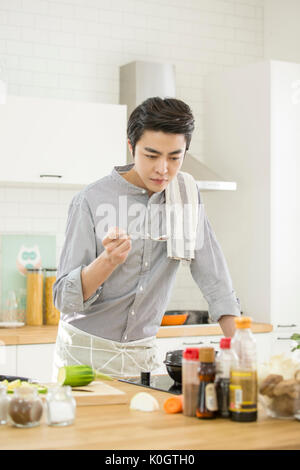 Single man cooking Stock Photo - Alamy