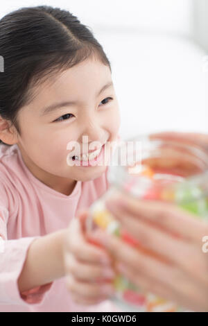 Girl taking candy Stock Photo - Alamy
