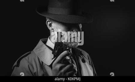 Detective holding a gun, he is wearing a fedora hat and a trench coat ...