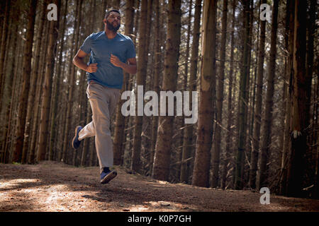 Man running by trees Stock Photo - Alamy