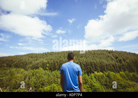Man standing on mountain against sky Stock Photo - Alamy