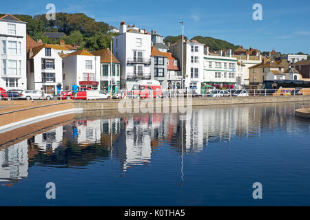 Hastings seafront promenade and houses reflected in the boating lake ...