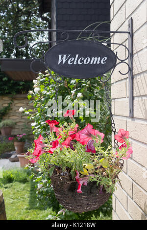 Welcome sign with flower decoration on wooden background Stock Photo ...