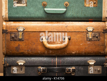 Vintage suitcases and trunk stacked together on top of each other in a ...