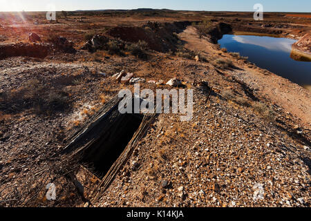 Abandoned mine shaft with open cut gold mine that has filled with water ...