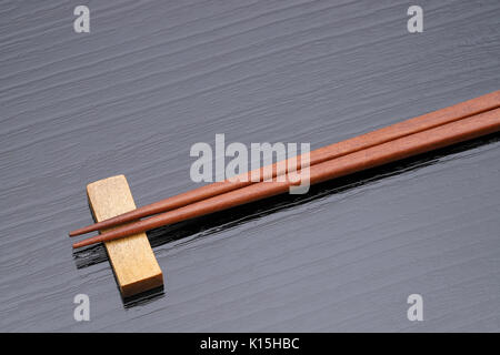 Chopsticks and chopsticks rest on black table background Stock Photo ...