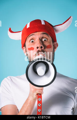 Fan of a team with a megaphone and a sad face for the defeat of her ...