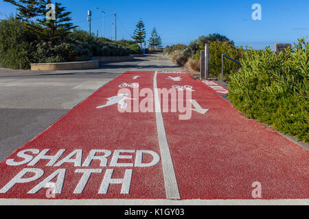 Slow Down Bicycle sign painted on concrete pavement on the Brisbane ...