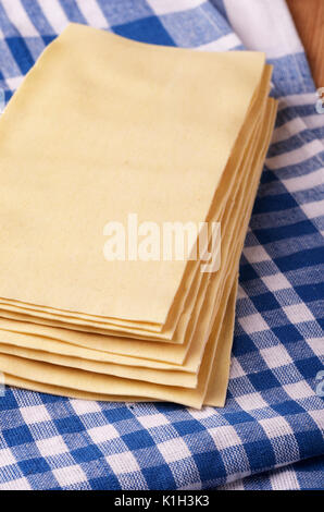 Raw lasagna pasta on blue surface food and drink concept Stock Photo ...