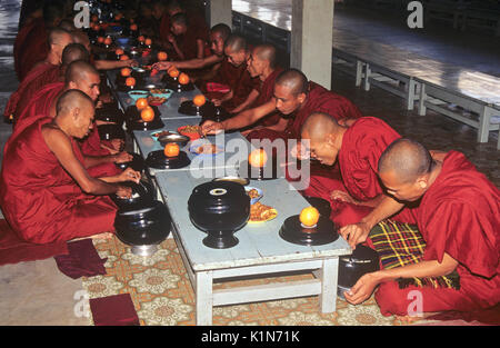 Myanmar, Mandalay. Buddhist monks eating in temple. Credit as: Jim ...