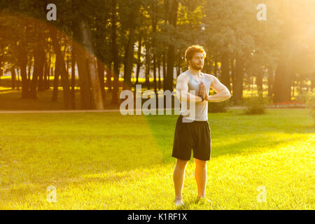 Young redhead man training yoga at sport center Stock Photo - Alamy