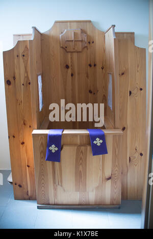 Grid of a confessional in a Christian church, with the symbol of the ...