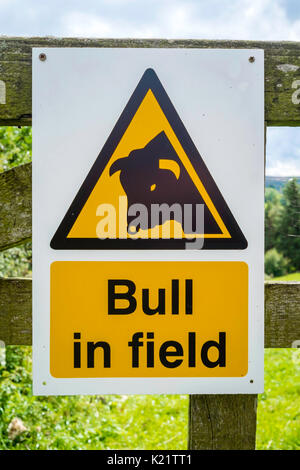 Warning sign of bull in the field, color filter applied Stock Photo - Alamy