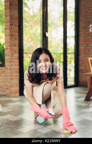Cleaning concept. Young woman washing floor on the kitchen Stock Photo - Alamy