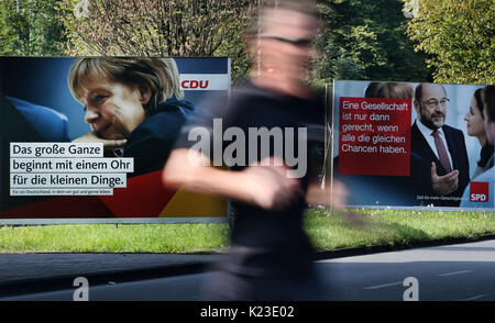 Cologne, Germany. 28th Aug, 2017. Campaign posters with the leading ...