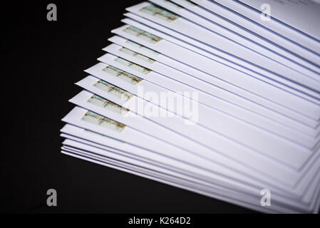 Stack of franked letters in white envelopes on black background Stock ...