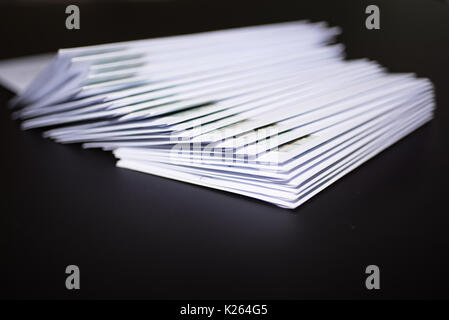 Stack of franked letters in white envelopes on black background Stock ...