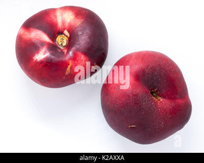 Two Nectarines sit on a white background Stock Photo - Alamy