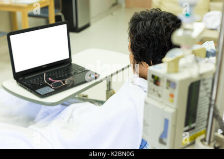 Female patient is watching computer screen for chat with children or ...