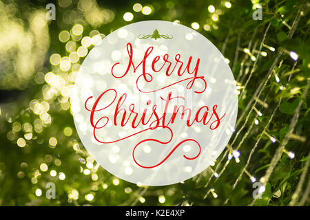 merry Christmas word on light box with green tinsel decoration Stock ...