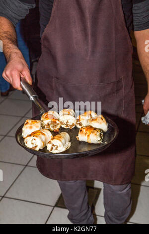 Chef holds metal baking sheet with apple strudel Stock Photo - Alamy
