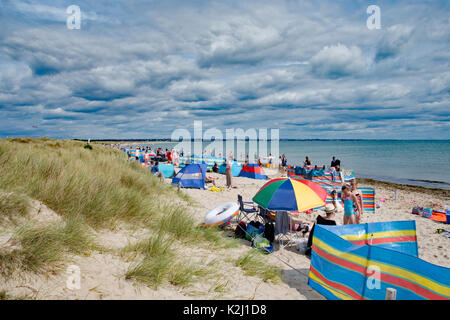 A crowded Knoll beach at Studland Bay on a hot sunny summers day ...