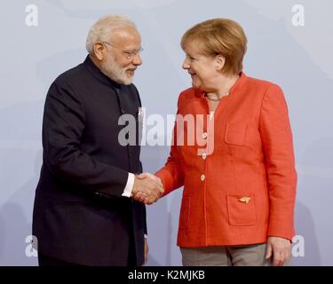German Chancellor Angela Merkel shakes the paw of Leo, the black ...