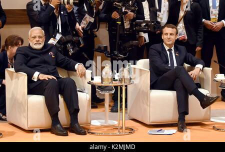 French President Emmanuel Macron sits with Indian Prime Minister ...
